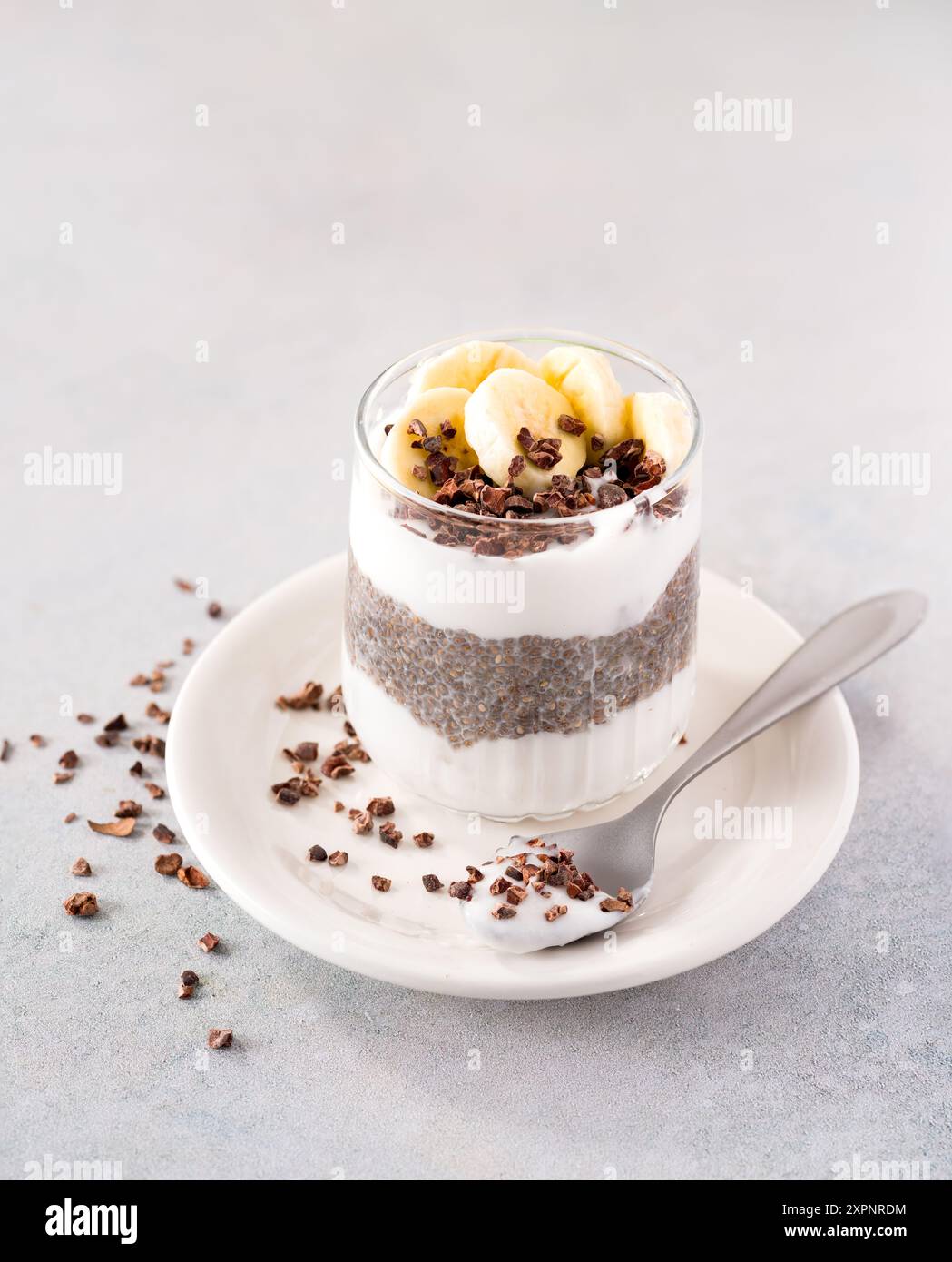 Plant-based chia pudding with raw coconut yogurt and topped cacao nibs ...