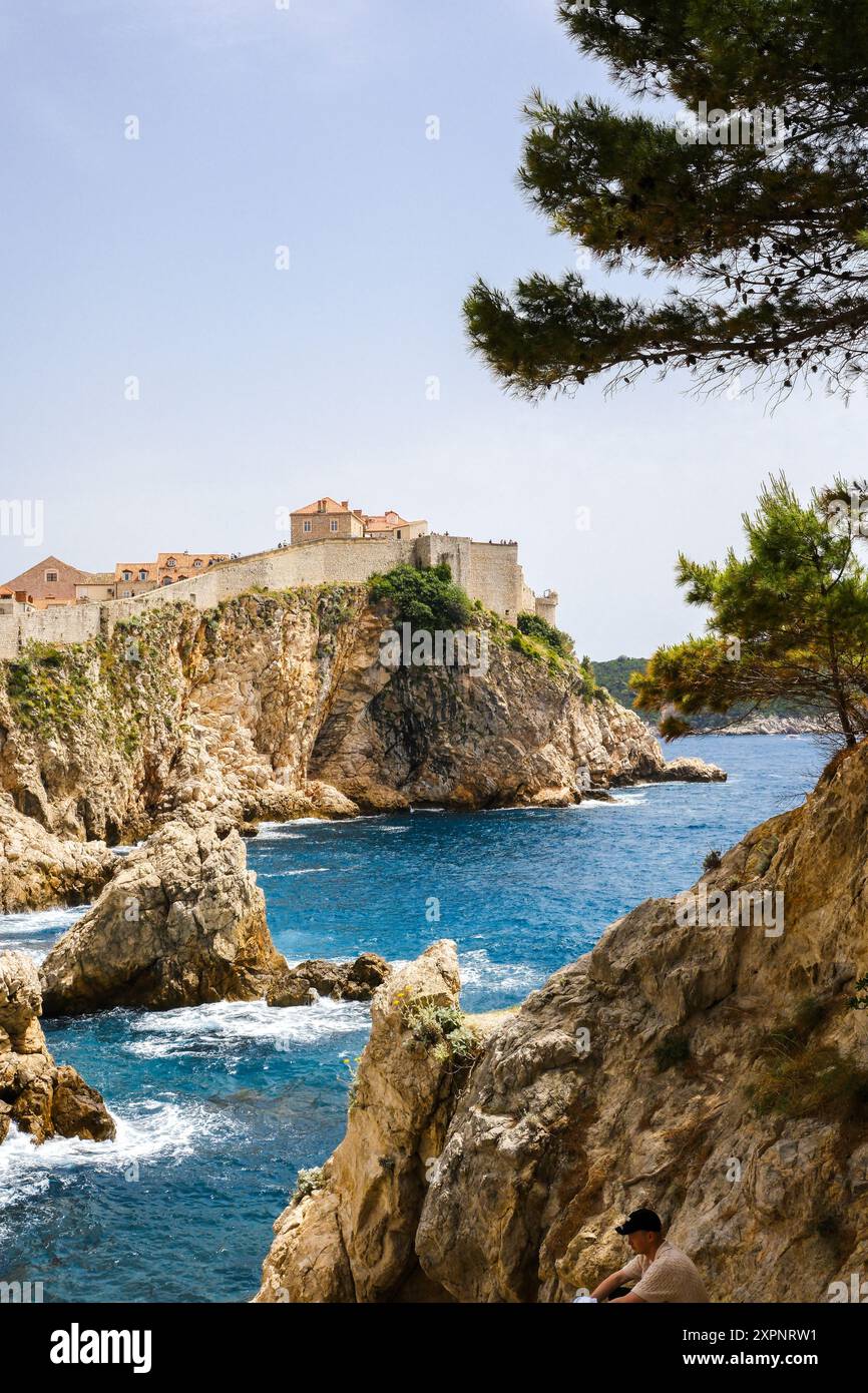 A scenic vertical view of Dubrovnik's old town fortified walls and ...