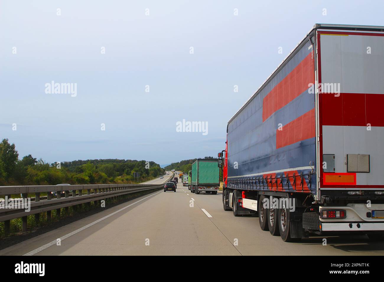 Heavy lorry traffic on right lane with long row of trucks on the ...
