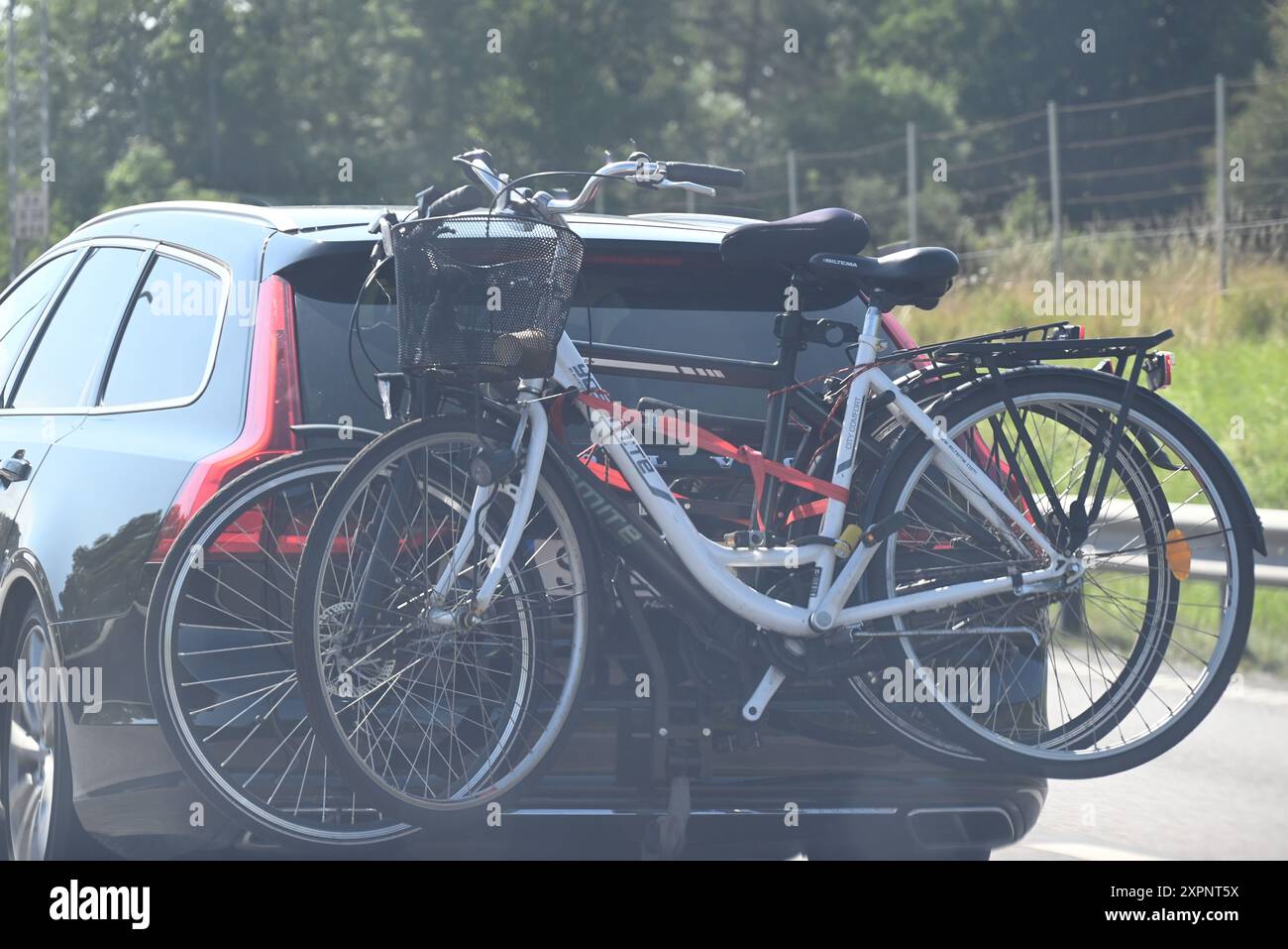 Black car travelling with bikes on bike rack Stock Photo - Alamy
