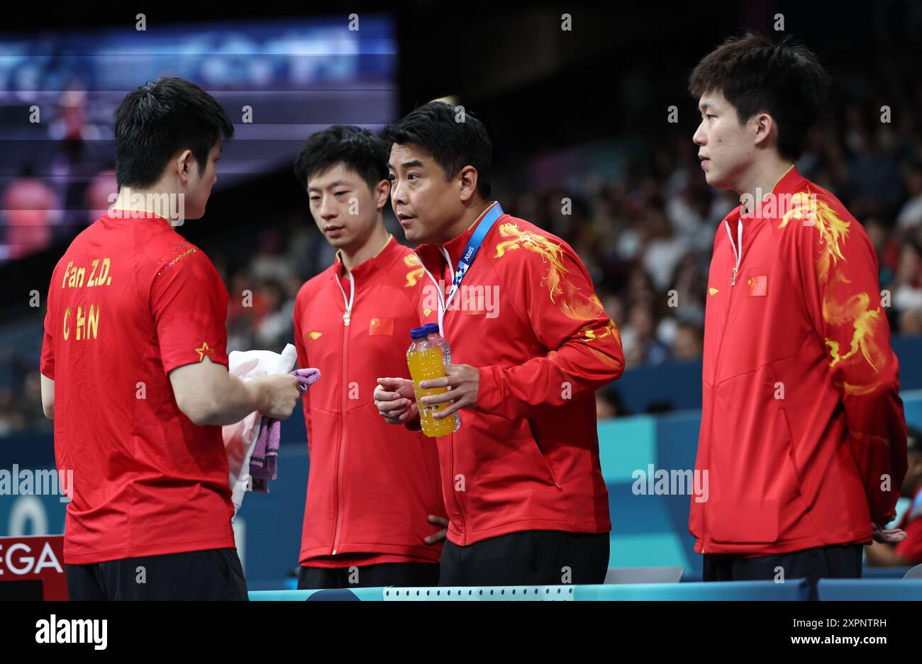 Paris, France. 7th Aug, 2024. Coach Wang Hao (2nd R) instructs Fan Zhendong (1st L) of china ...