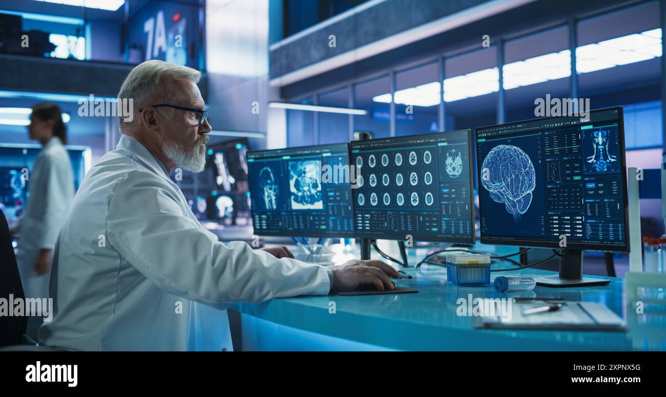 Senior Male Neuroscientist Using Desktop Computer To Analyze MRI Scans ...