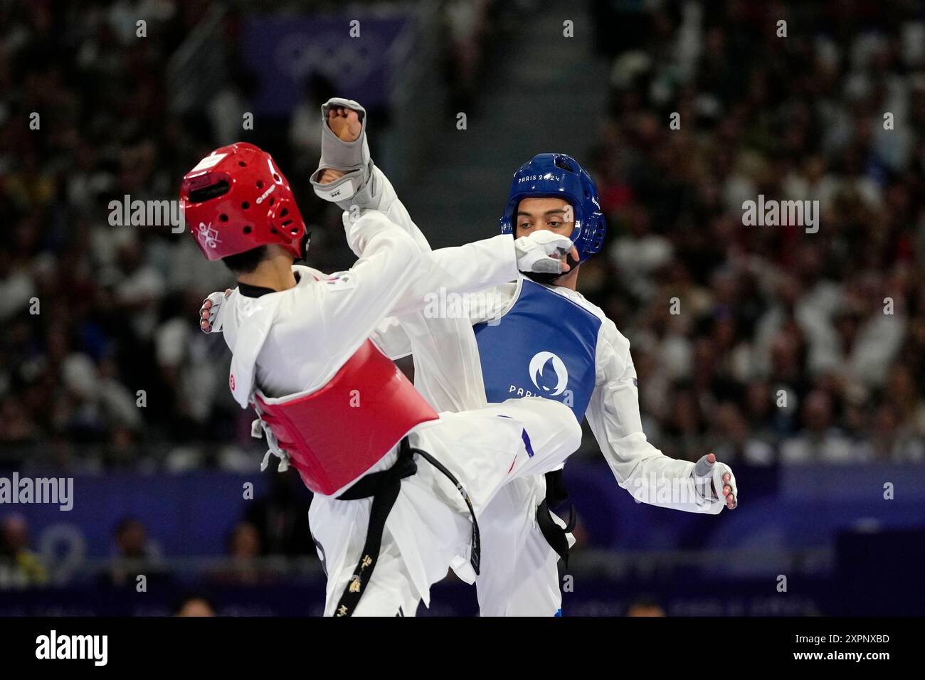 France's Cyrian Ravet competes with Korea's Taejoon Park in a men's ...