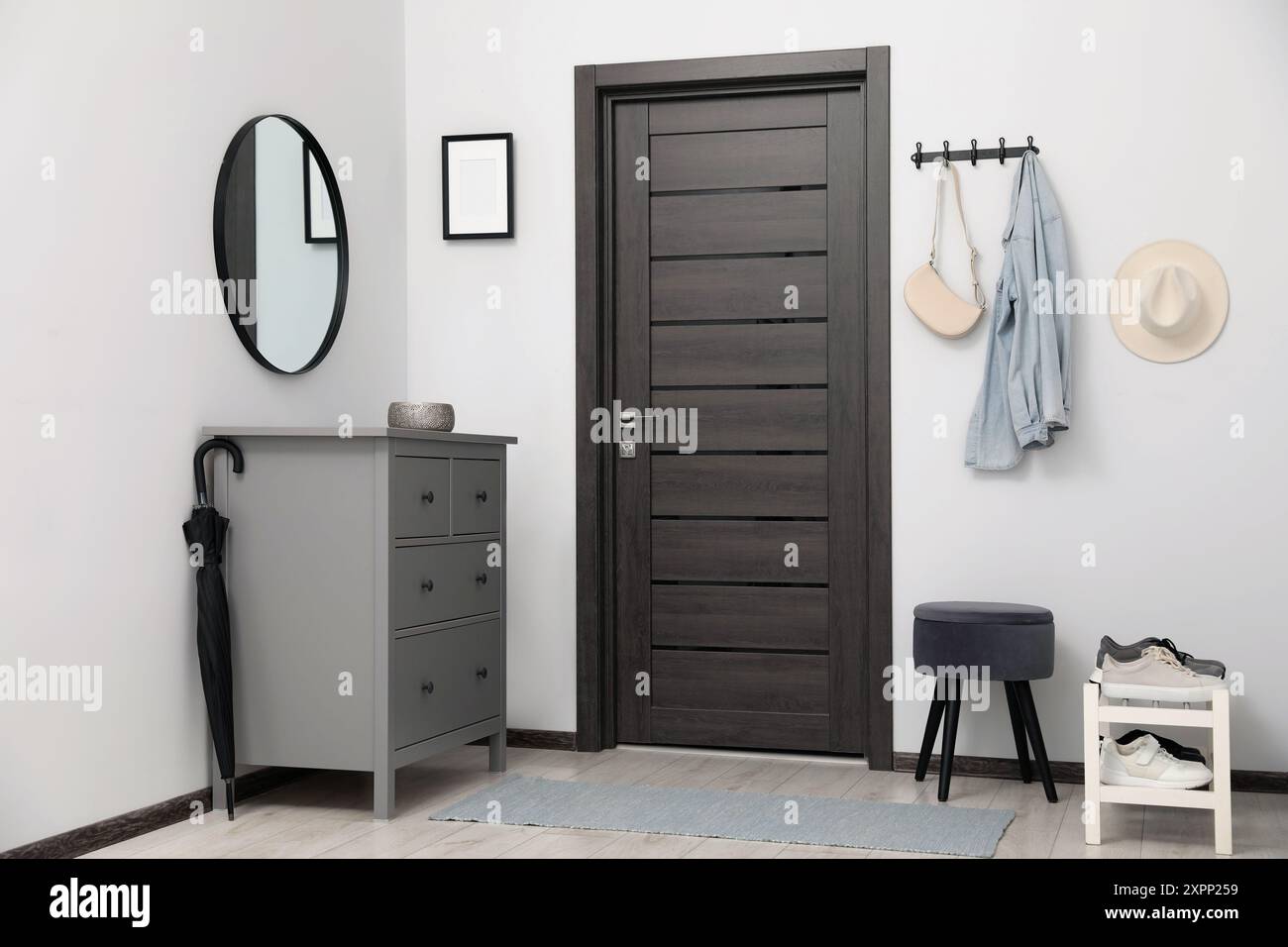 Chest of drawers, mirror and shoe storage bench in hallway. Interior ...