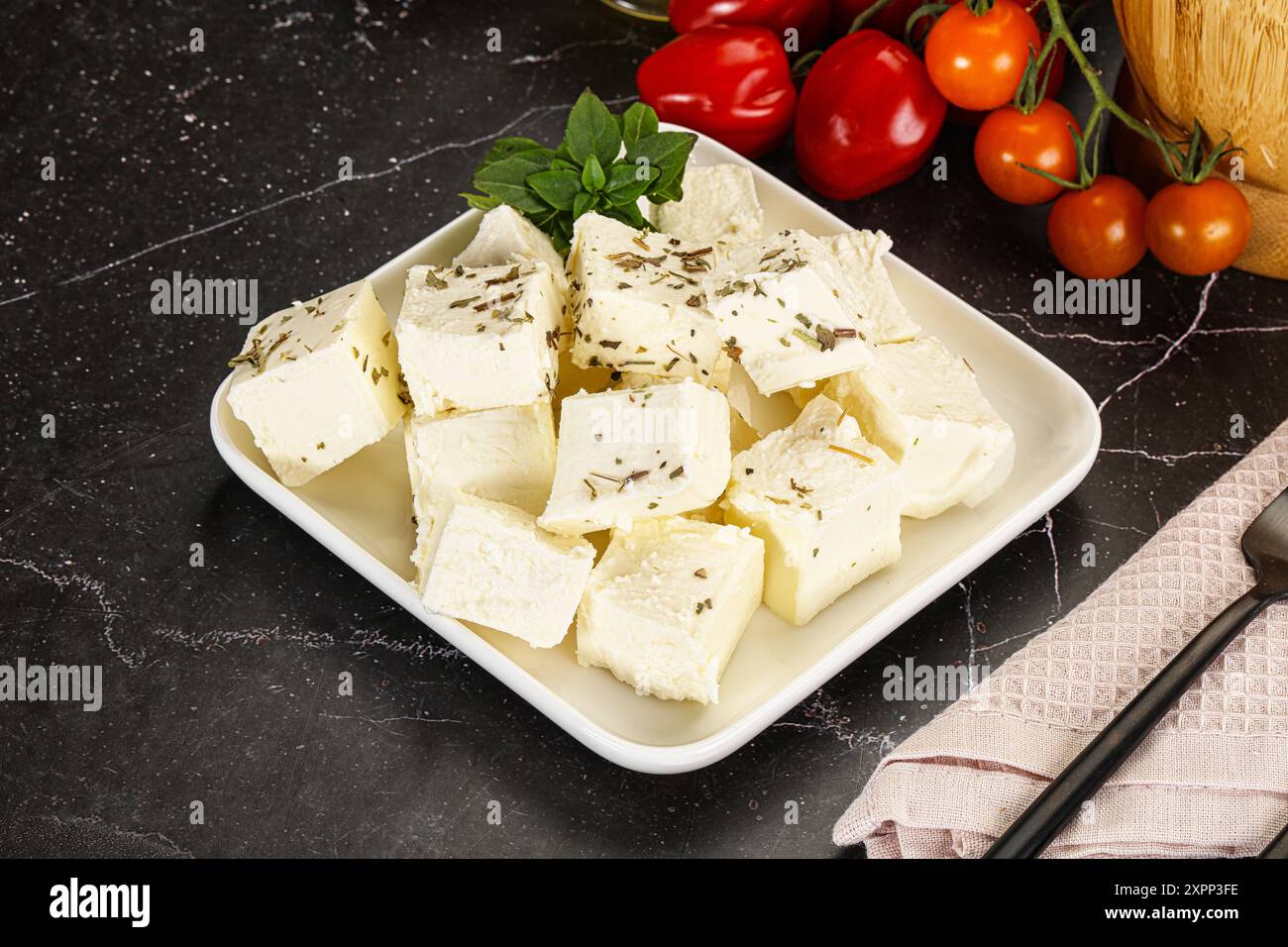 Greek traditional Feta cheese cubes with herbs and spices Stock Photo ...