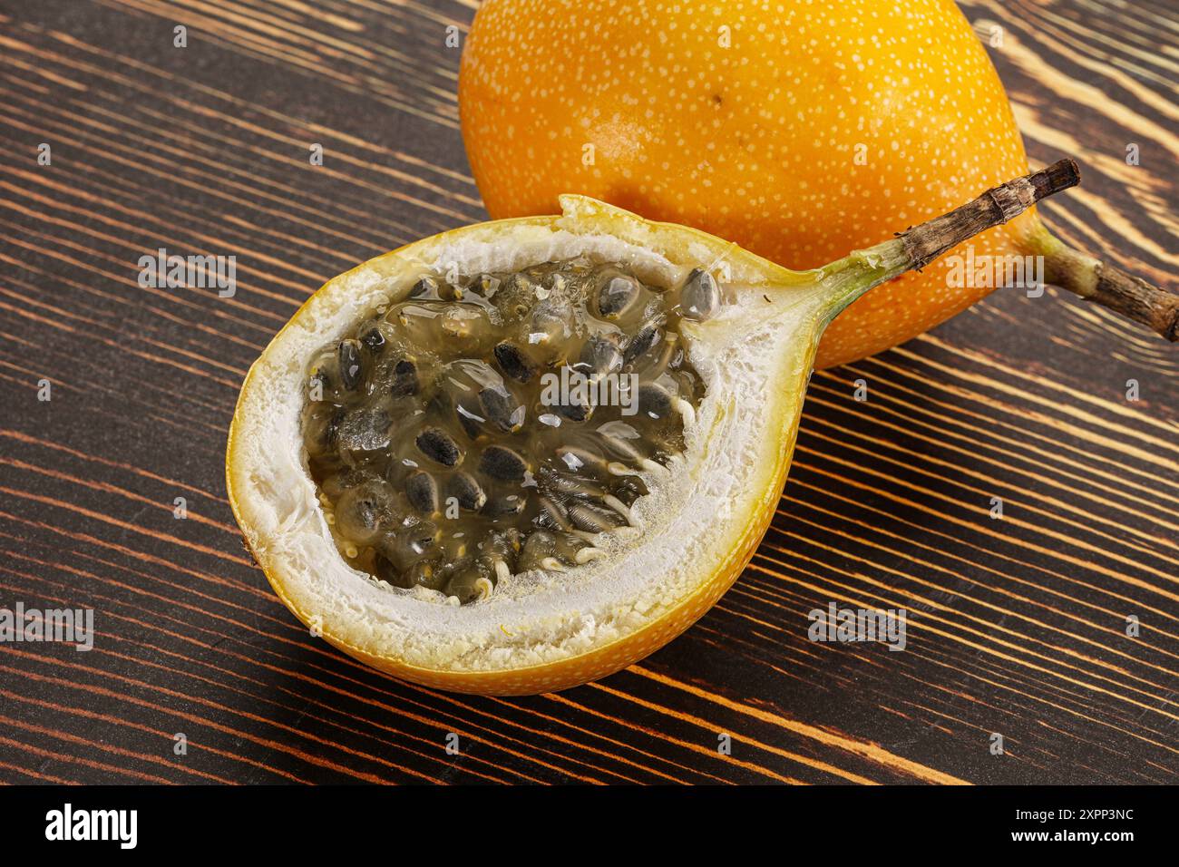 Yellow granadilla fruit with cut half Stock Photo - Alamy