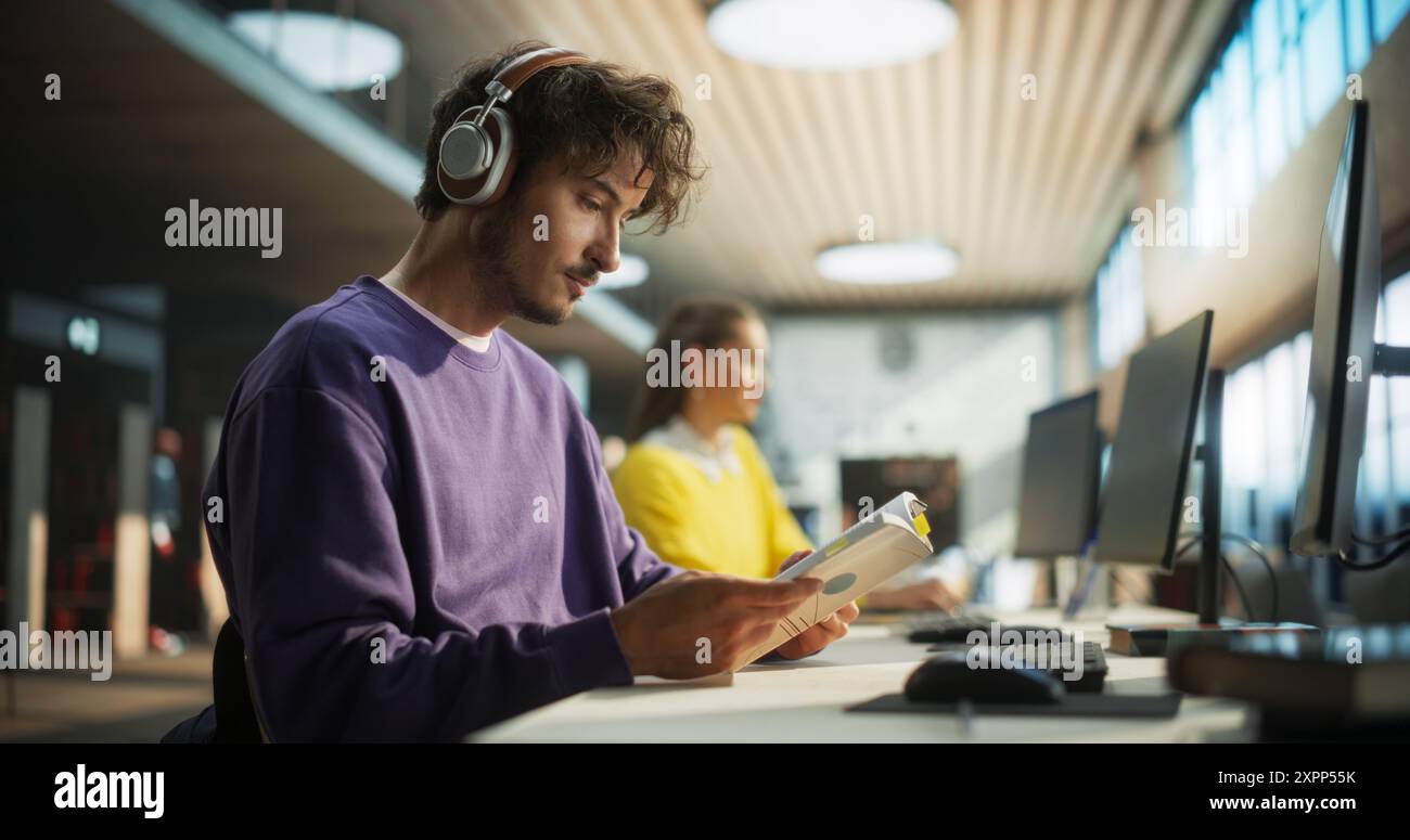 Handsome University Student Studying in a Traditional Public Library ...