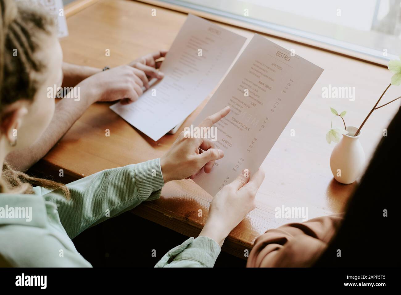Selecting Items from Restaurant Menu by Table Window Stock Photo - Alamy