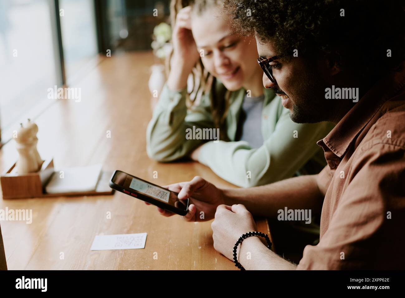 Reading Text Messages and Smiling at the Cafe Stock Photo - Alamy