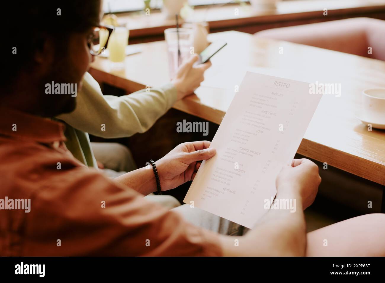 Reading Cafe Menu While Enjoying Conversation Stock Photo - Alamy