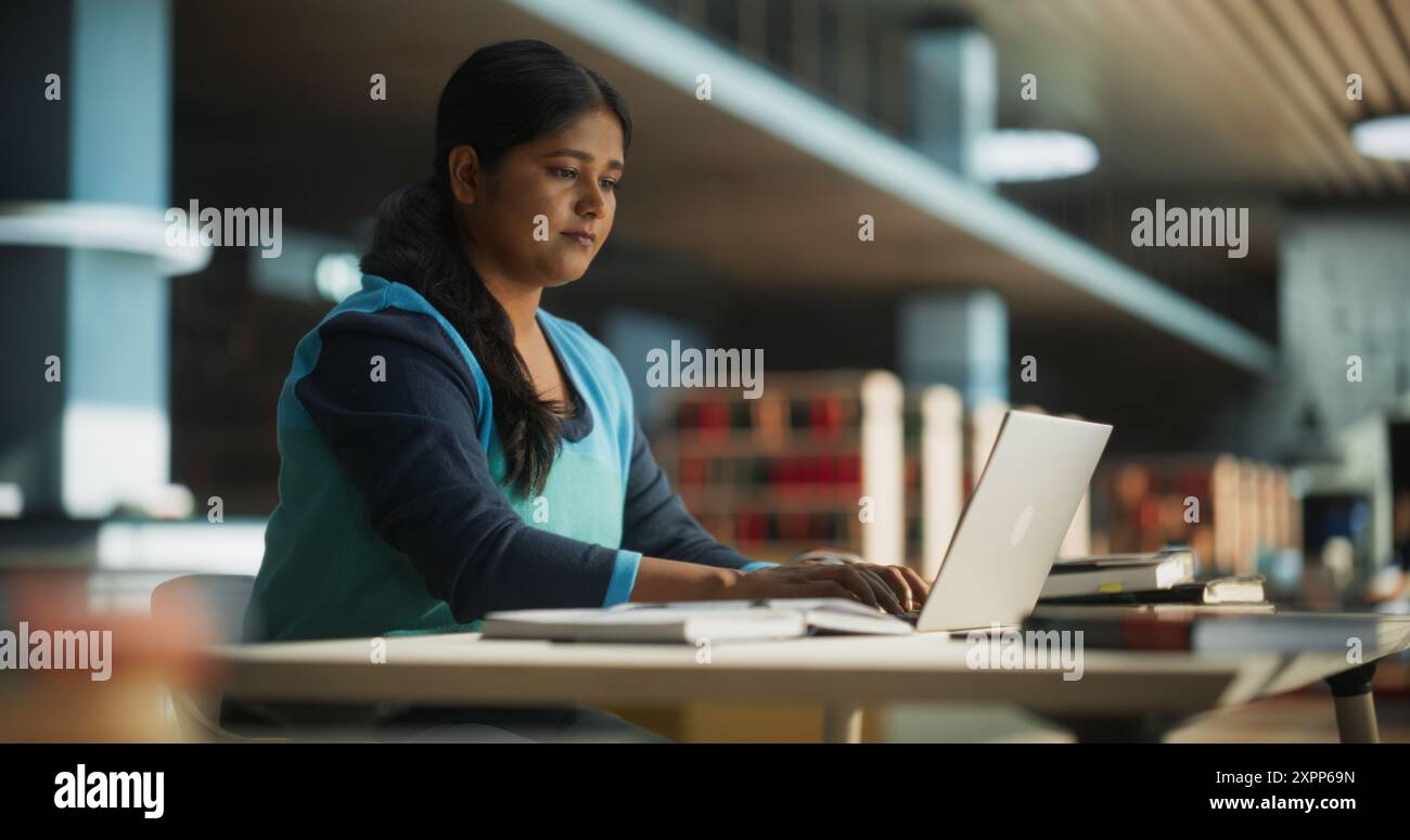 Focused Indian Female Working on a College Project for Class Assignment ...