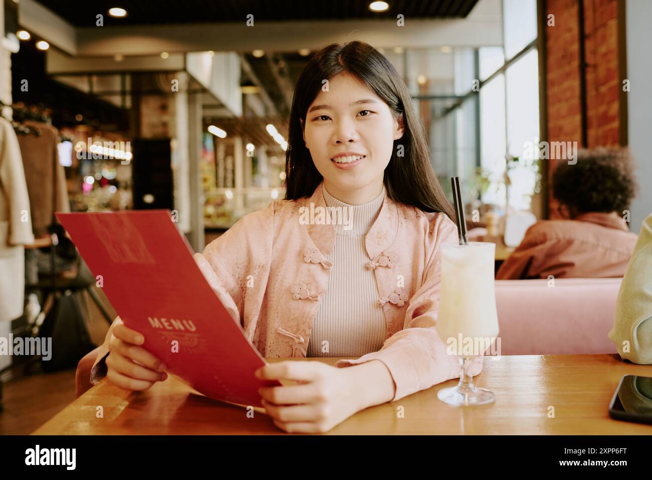 Portrait of Woman Reading Menu in Cozy Cafe Setting Stock Photo - Alamy