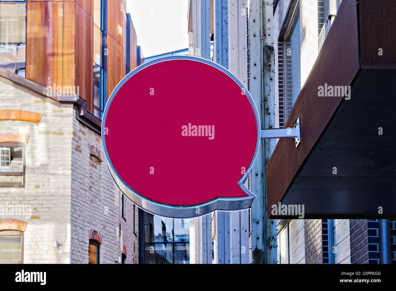 Round blank signboard mockup hung on business facade. Outdoor store ...