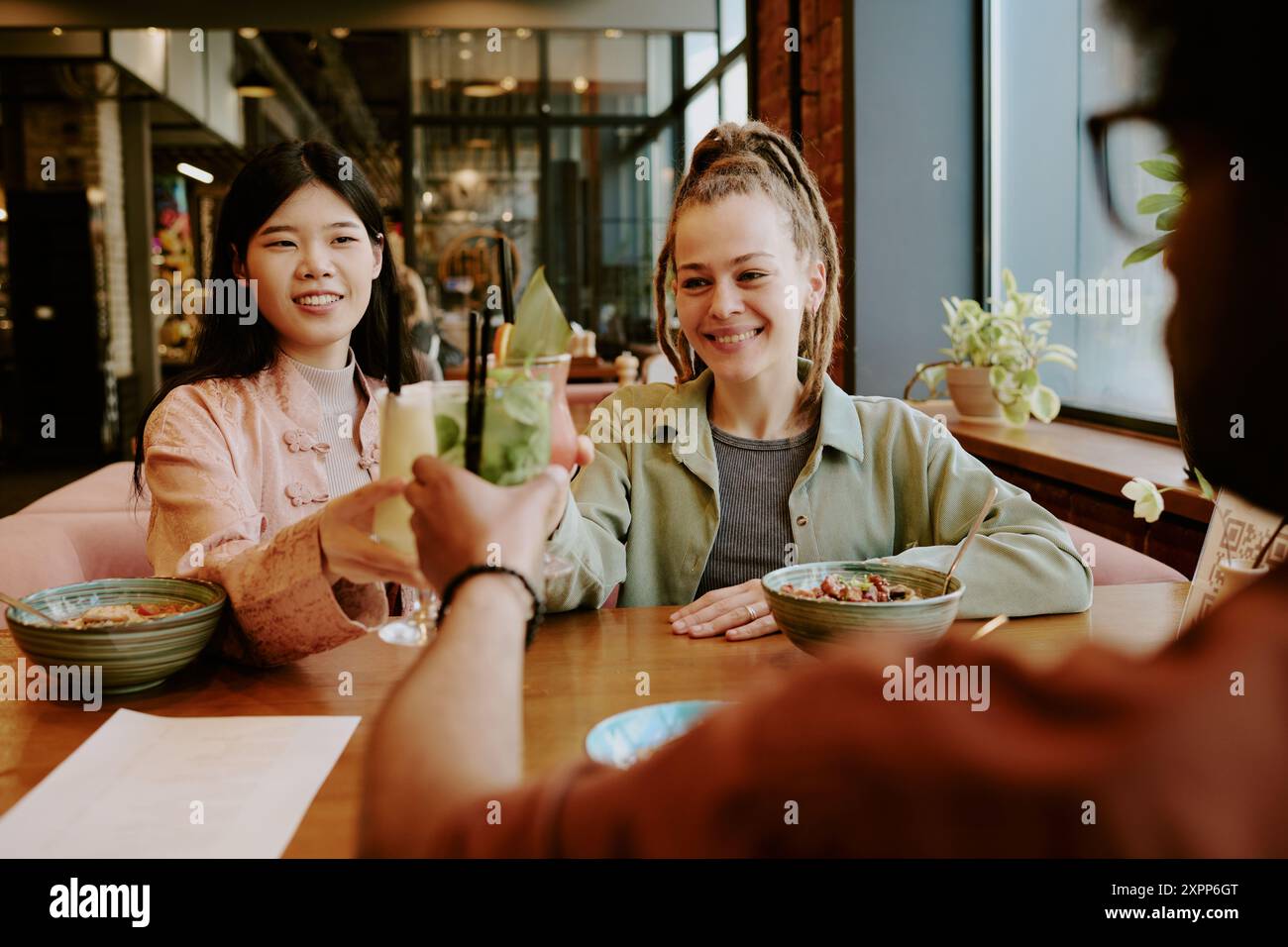 Smiling Friends Enjoying Asian Cuisine at Cozy Restaurant Stock Photo ...