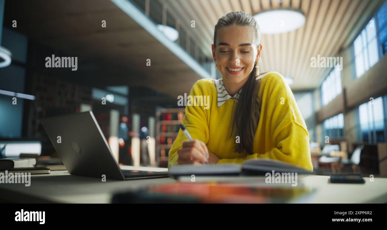 Happy and Focused Student Studying in a Modern Library. Young Female ...