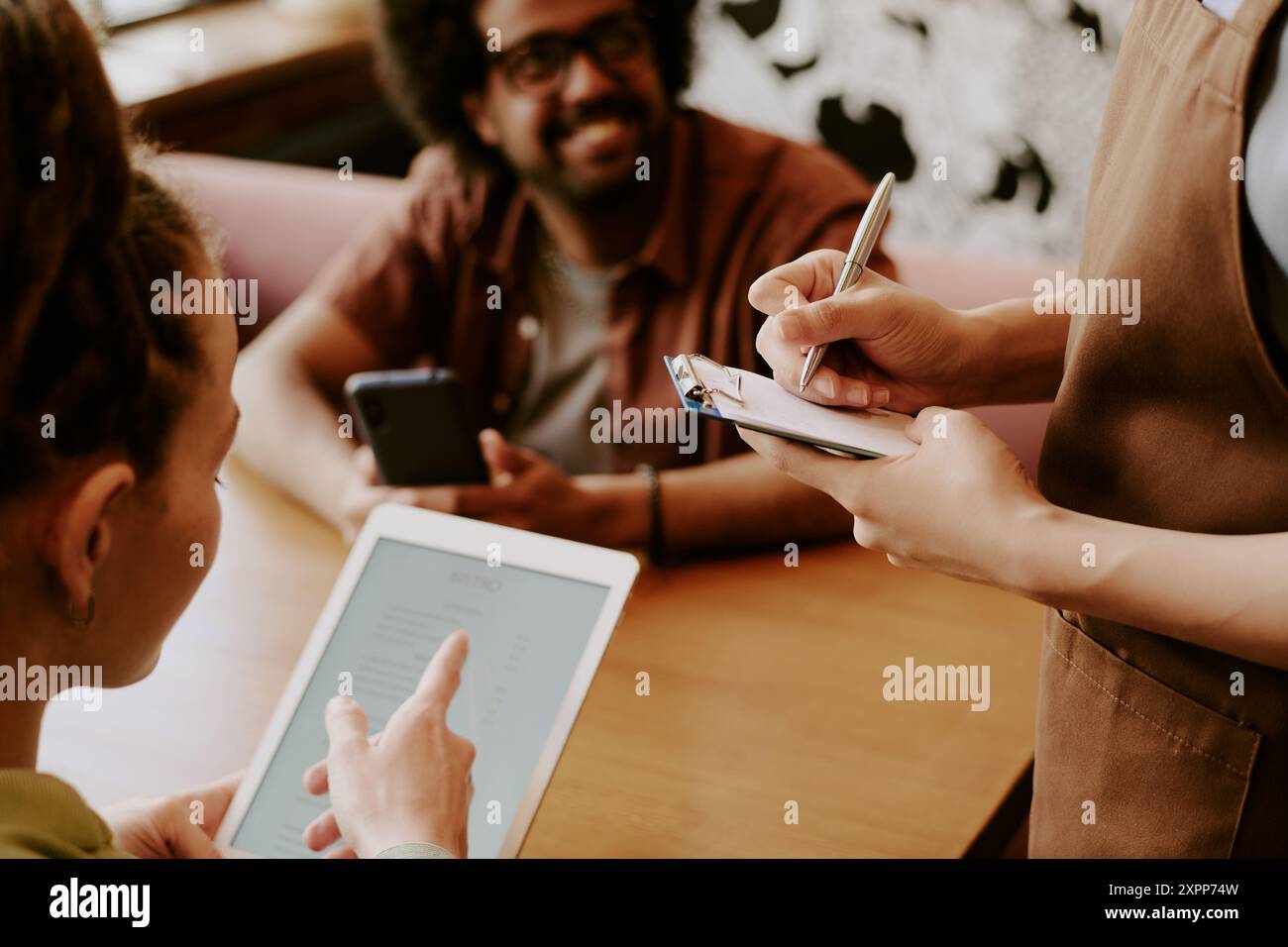 Taking order in restaurant using device hi-res stock photography and ...