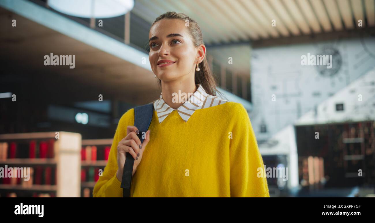 Portrait of a Young Attractive Female Walking Inside a Library Building ...