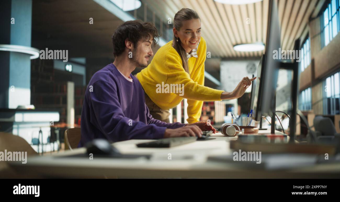Two Young Students Studying in a College Library. Female Helping Her ...