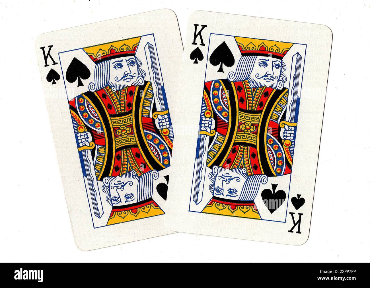 A pair of vintage king of spades playing cards on a white background ...