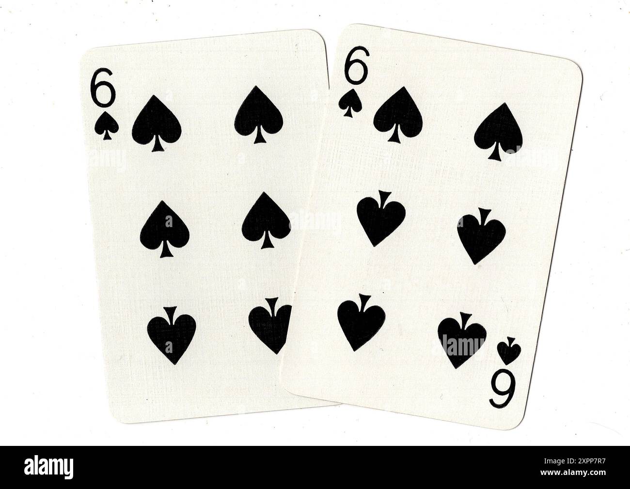 A pair of vintage six of spades playing cards on a white background ...