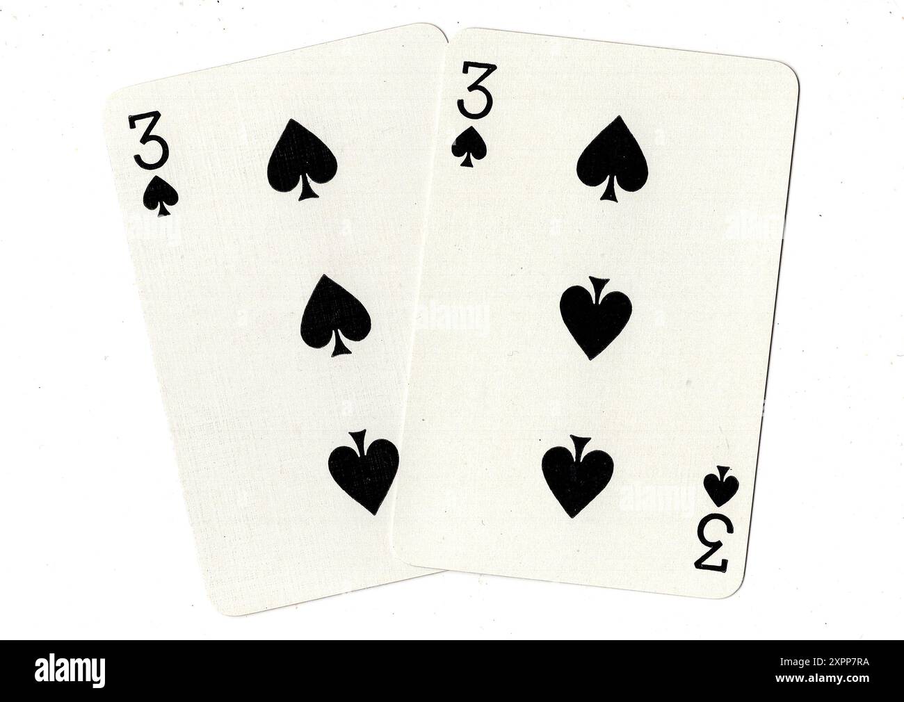 A pair of vintage three of spades playing cards on a white background ...