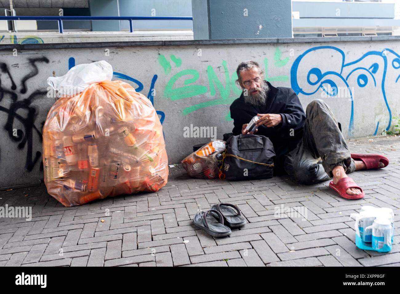 Homeless man taking plastic bottle hi-res stock photography and images ...