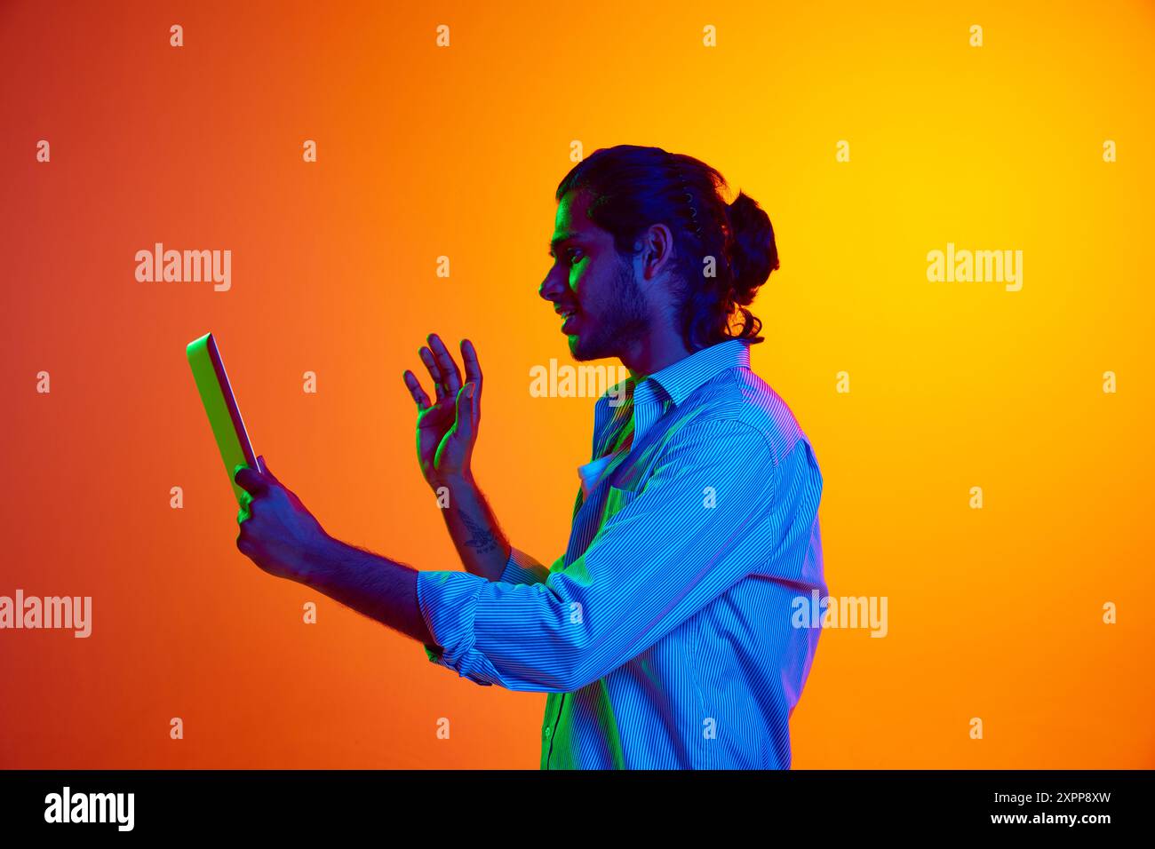 Cheerful young middle eastern man waving hello calling his friends in ...