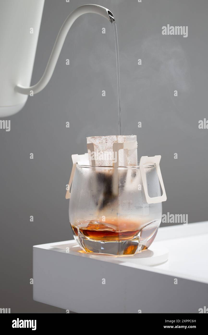 A drip bag methodically filters water through coffee grounds ...