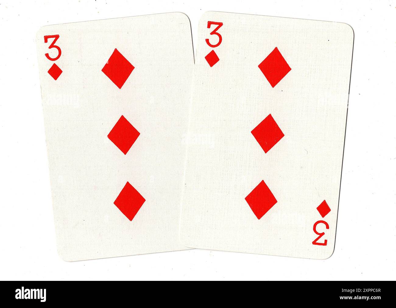 A pair of vintage three of diamonds playing cards on a white background ...