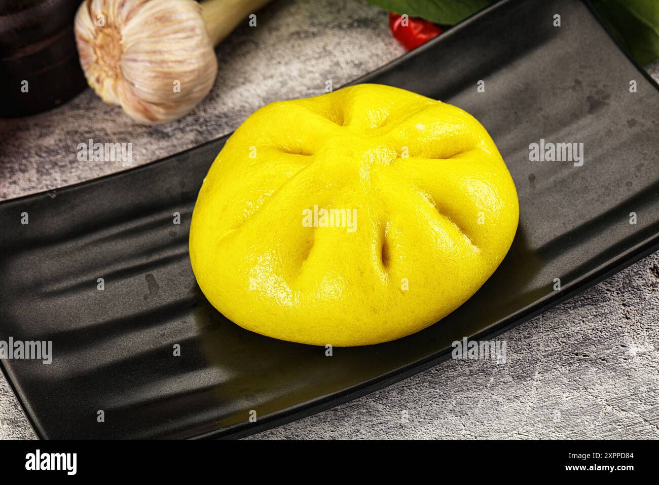 Asian stuffed steamed yellow Bun Bao Stock Photo - Alamy