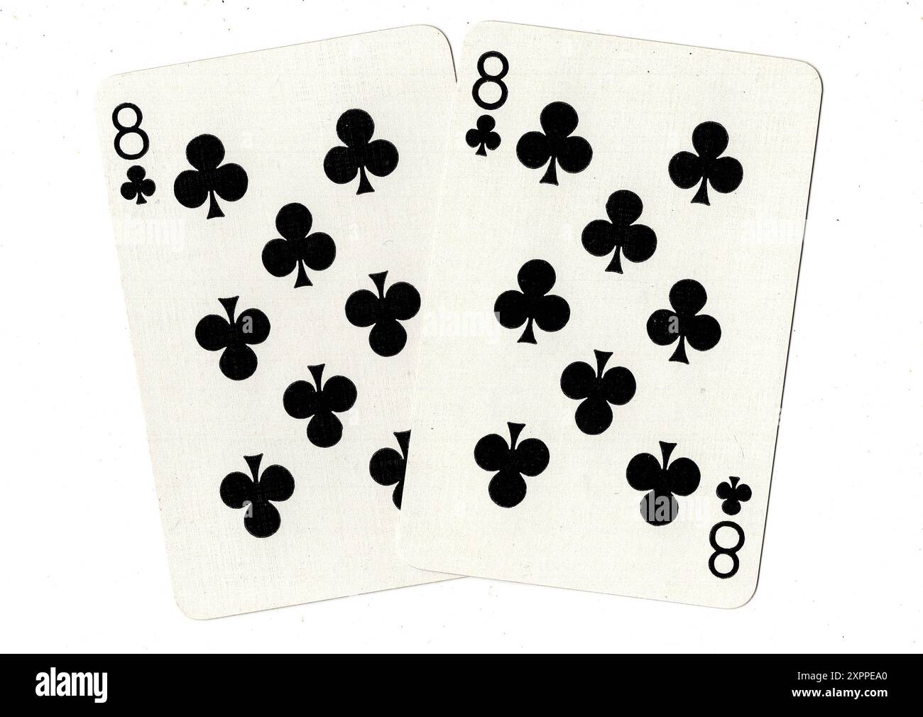 A pair of vintage eight of clubs playing cards on a white background ...