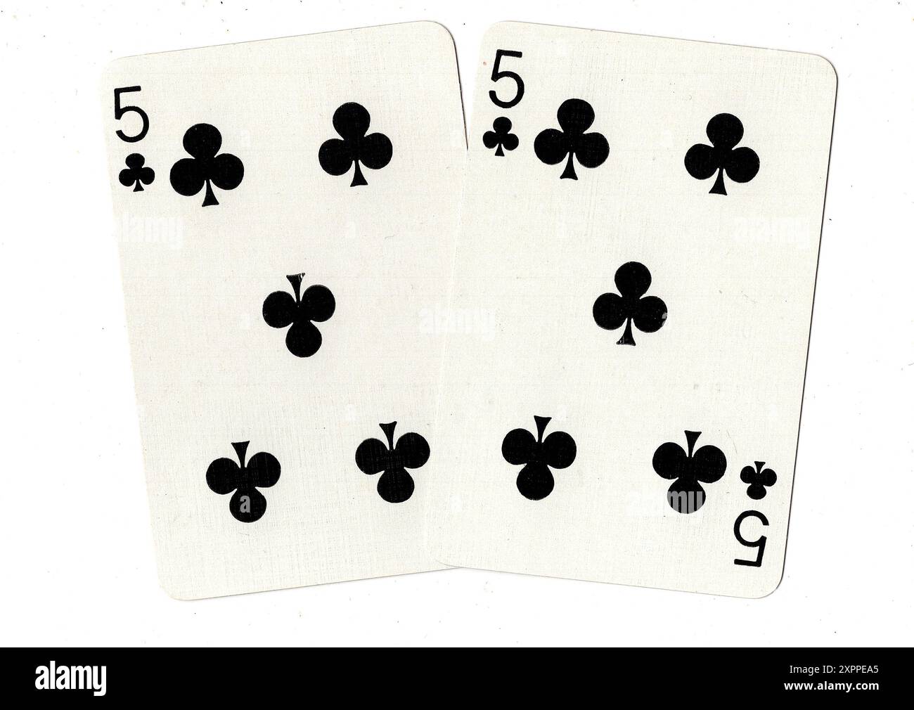 A pair of vintage five of clubs playing cards on a white background ...