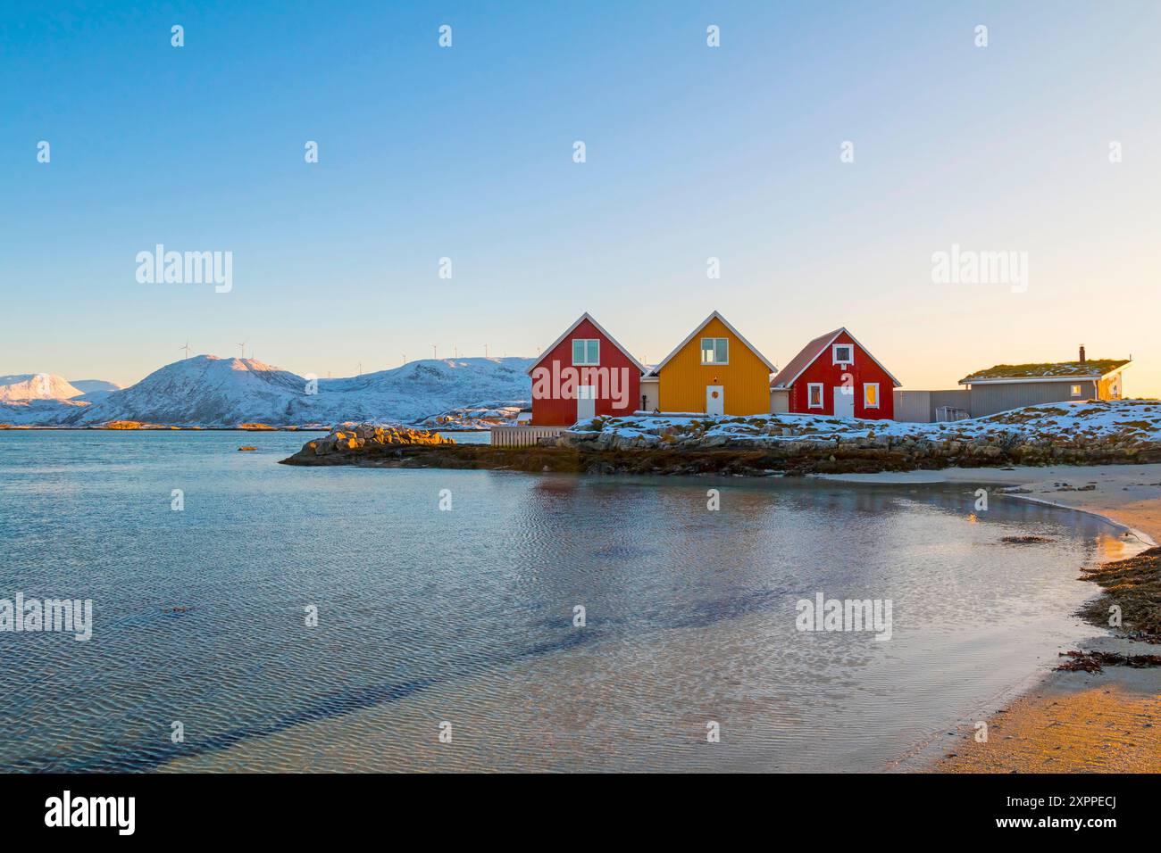 Traditional red and yellow wooden norwegian cabins with ground on the ...