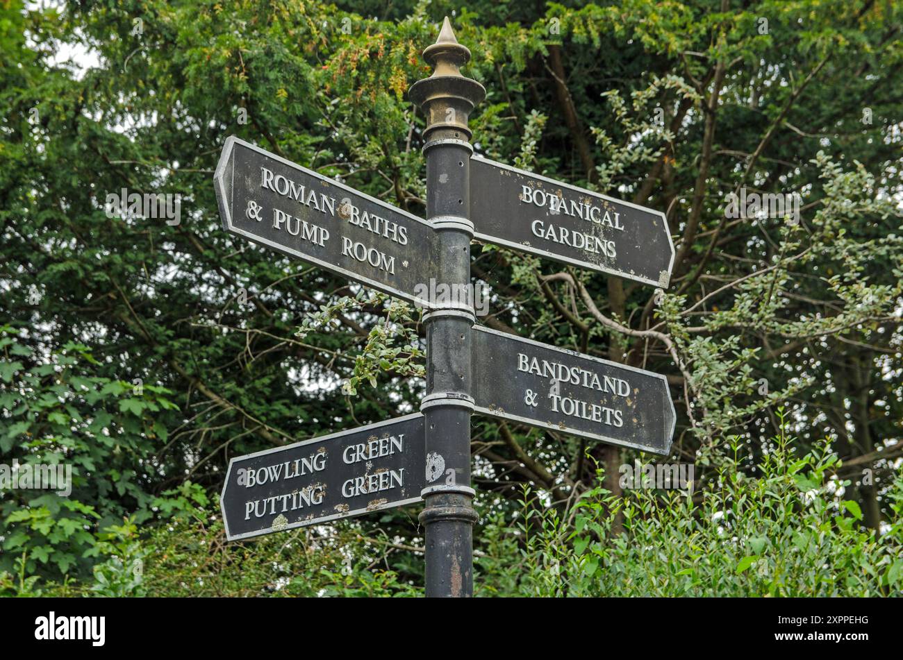 A sign post pointing pedestrians to some of the attractions in the ...