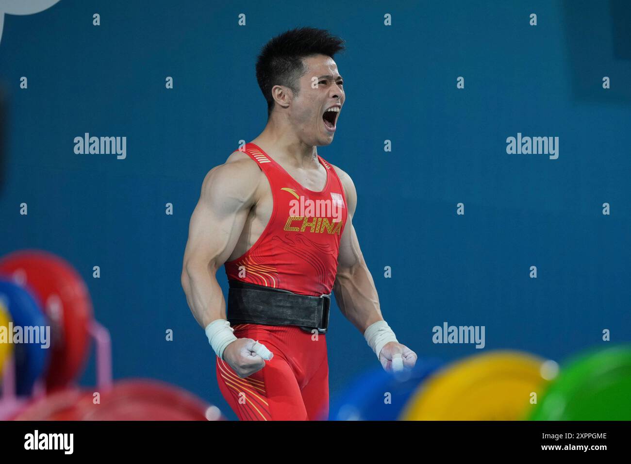 Li Fabin of China reacts as he competes during the men's 61kg ...