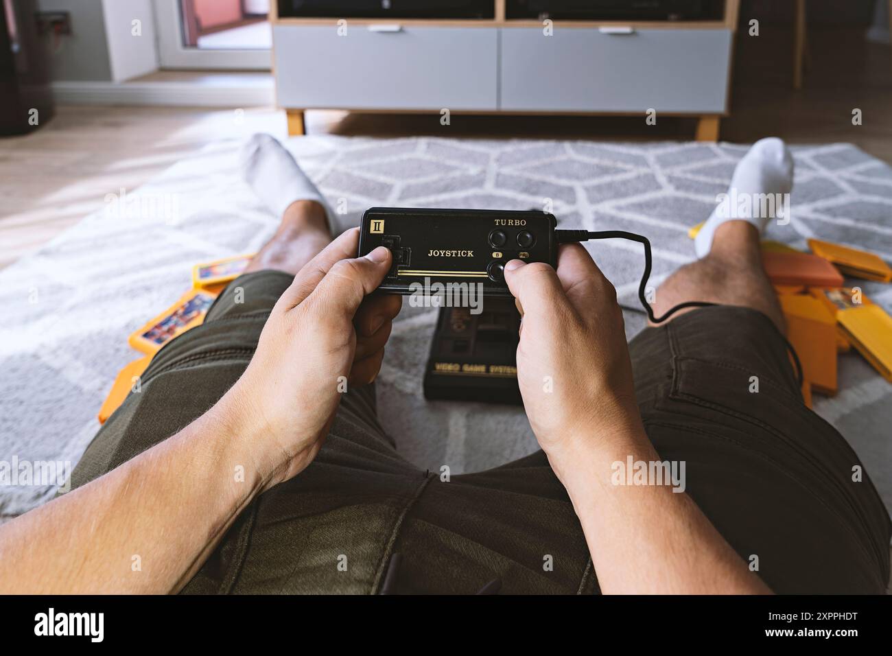 Male hands holding joystick from video-game console against background ...