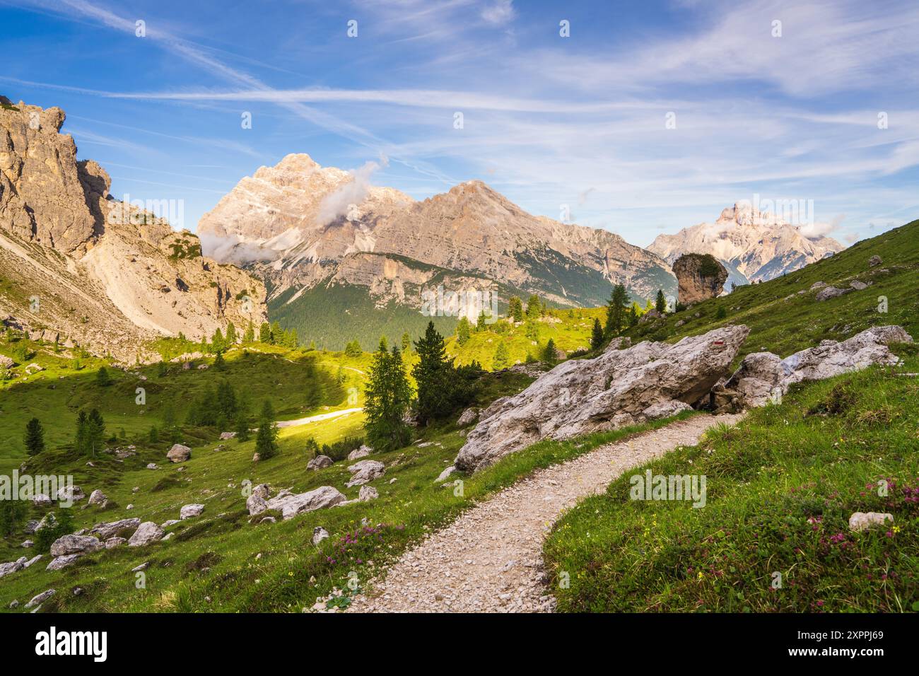 Majestic mountains of the Dolomites. Emerald green grass. tourist trail ...