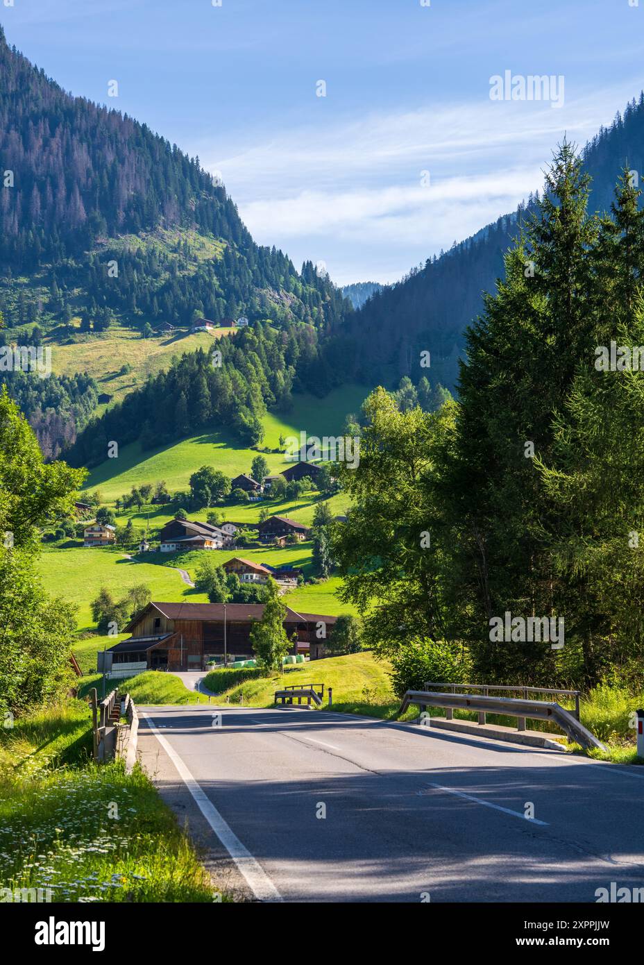 Beautiful village with houses on green grassy hills and majestic ...