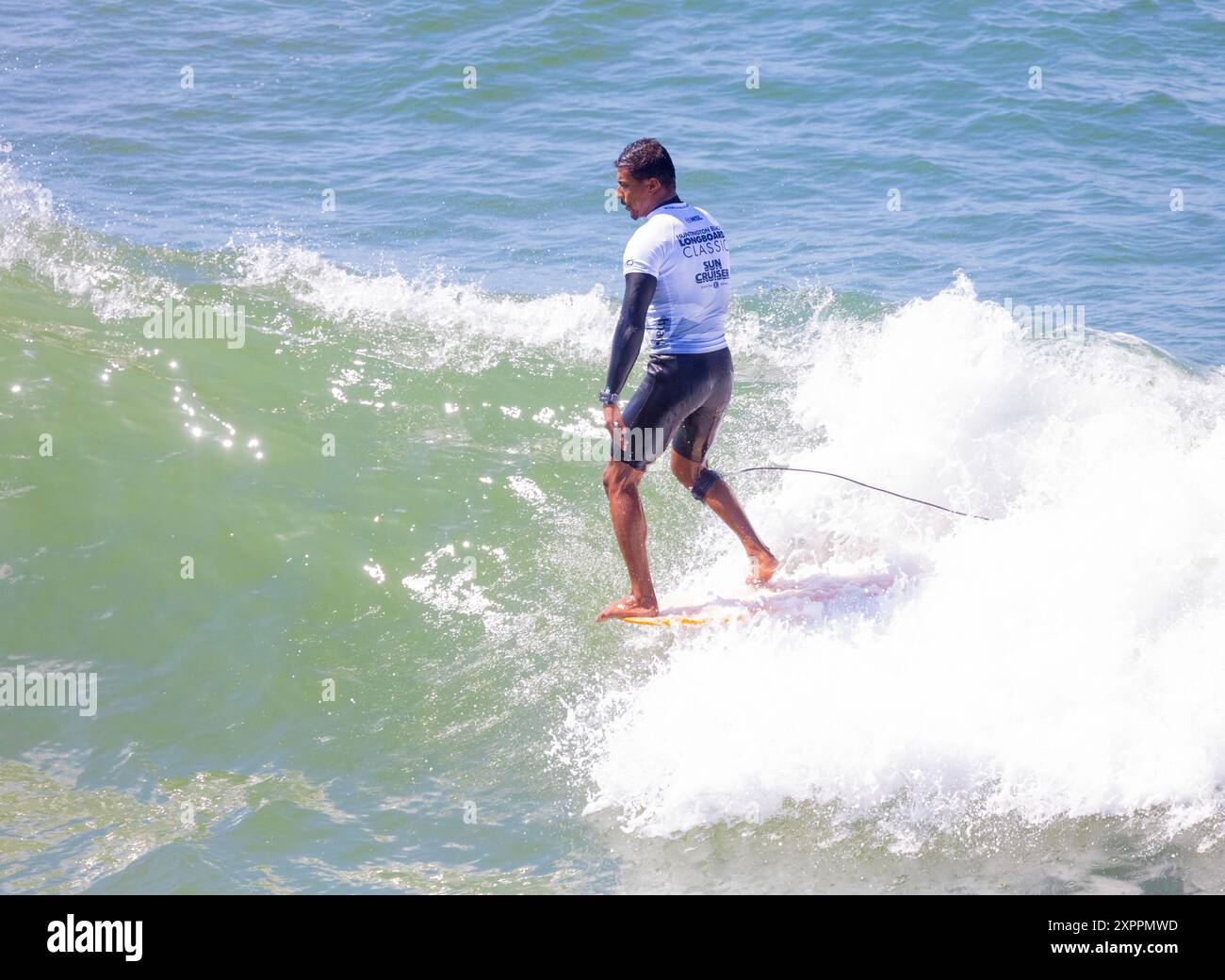Longboard Surfer Hanging Five on Tip of Board Stock Photo - Alamy