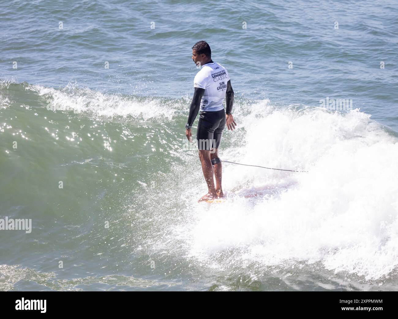 Longboard Surfer Hanging Ten on Tip of Board Riding Breaking Wave Stock ...