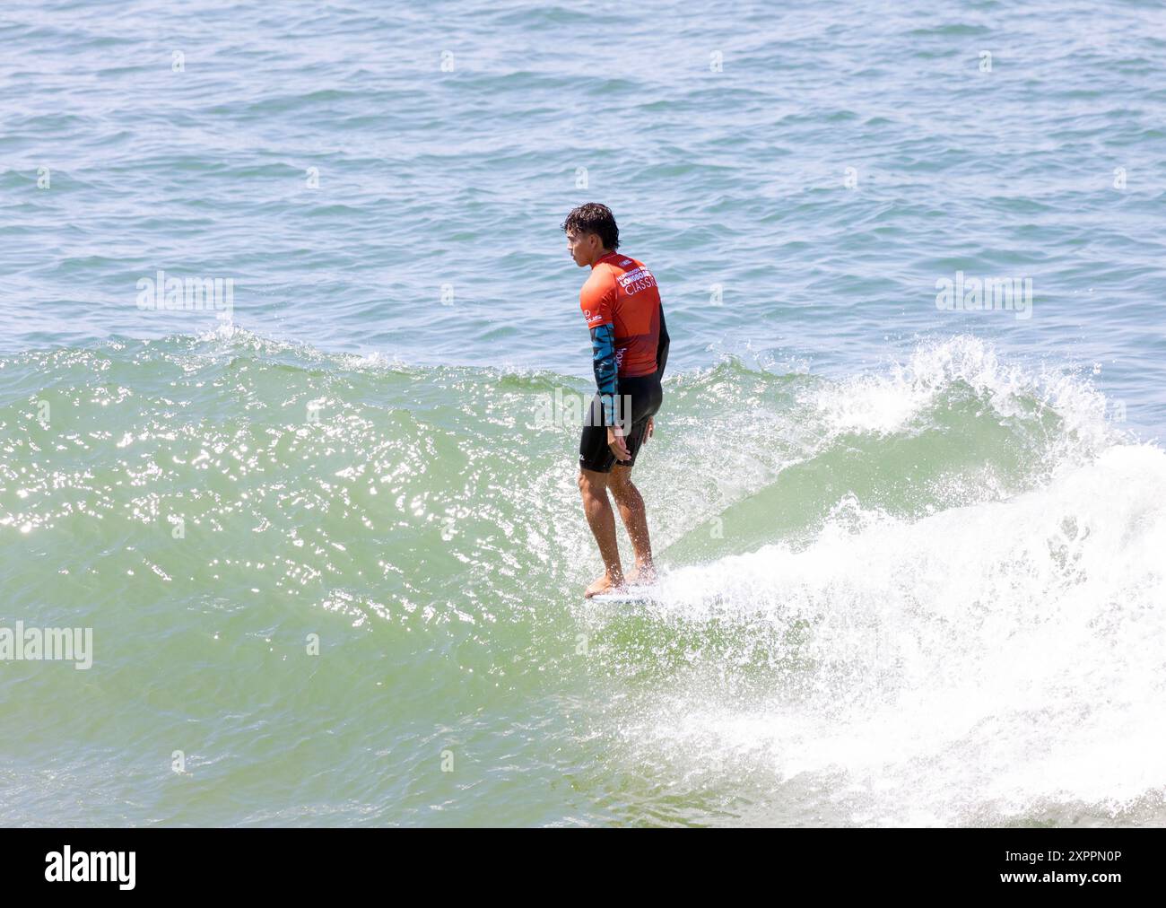 Longboard Surfer Hanging Ten on Tip of Board Riding Breaking Wave Stock ...