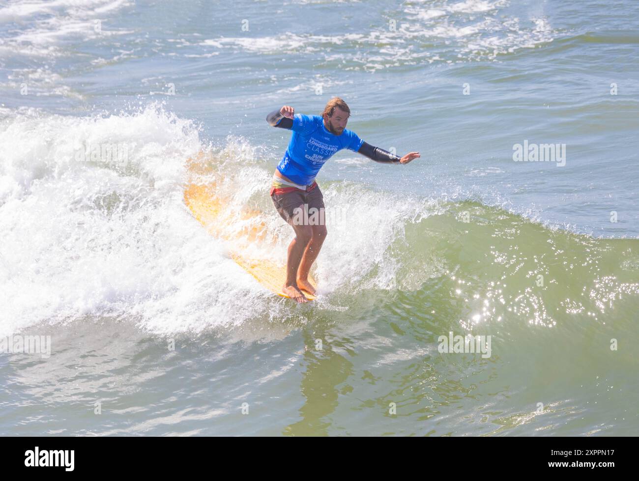 Longboard Surfer Hanging Ten on Tip of Board Riding Breaking Wave Stock ...
