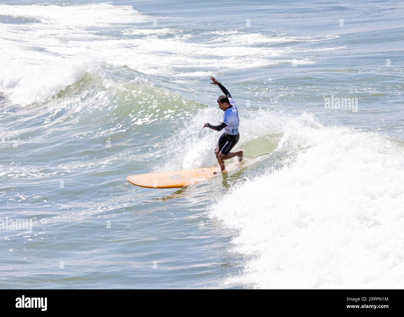 Longboard Surfer One Foot Raised Riding Wave Stock Photo - Alamy