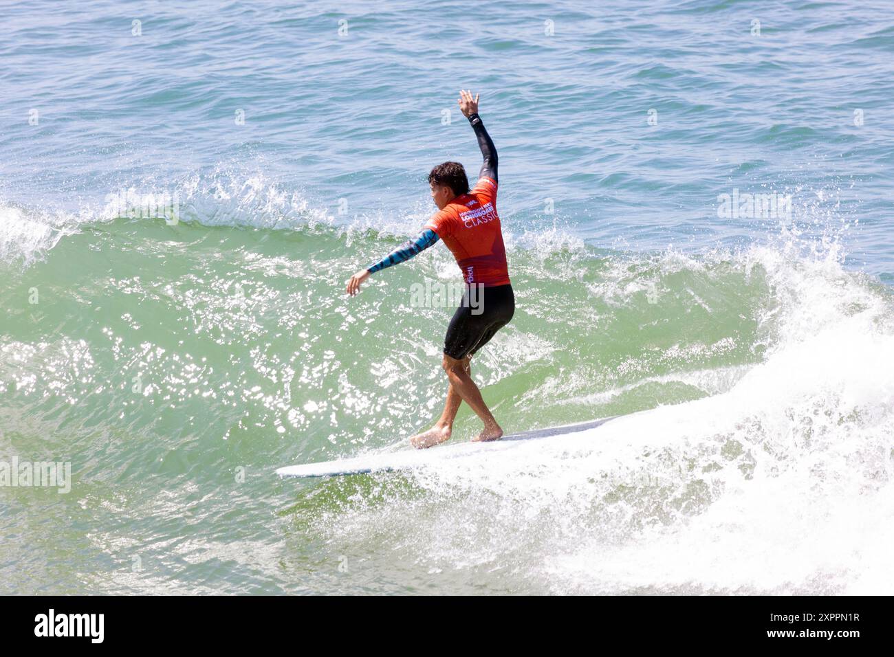 Longboard Surfer One Foot Raised Riding Wave Stock Photo - Alamy