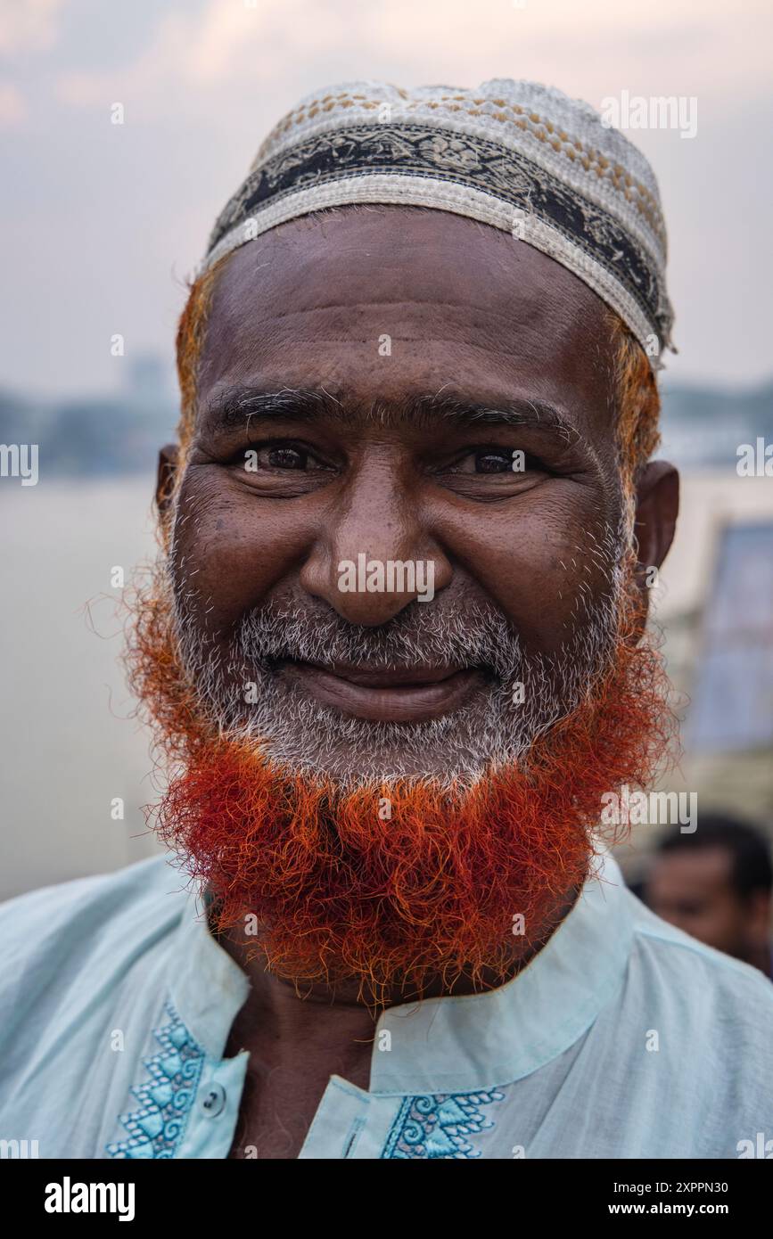 Portrait of a smiling Muslim man with an orange beard symbolizing that ...