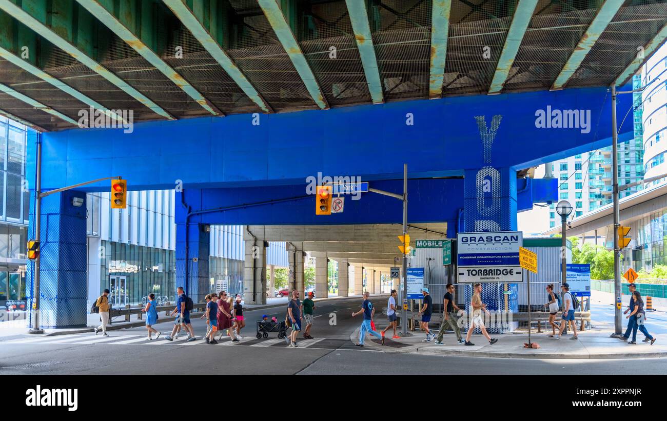 Toronto, Canada - August 5, 2024: Pedestrians in a crosswalk below the ...