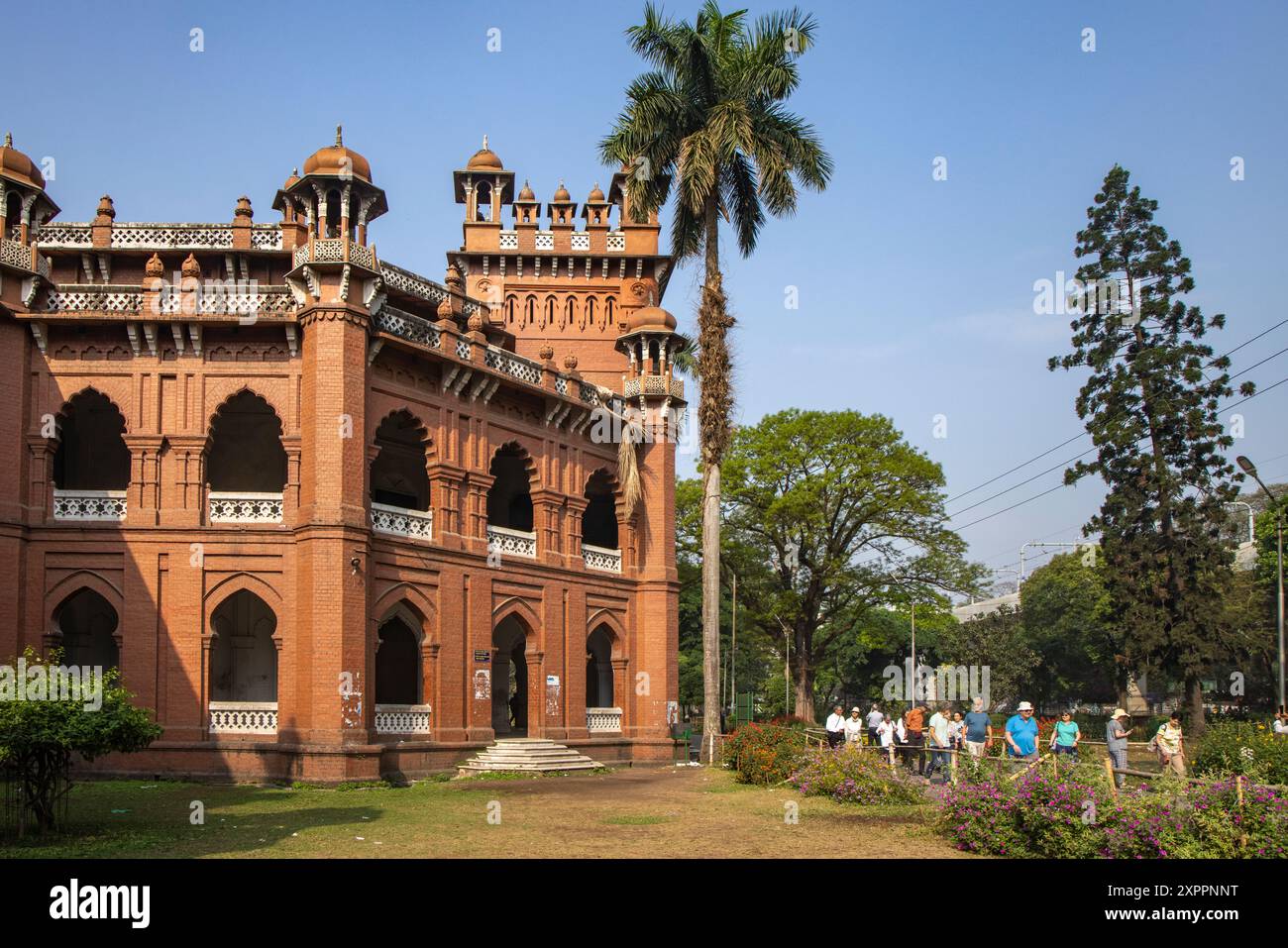 Tour group walks past Curzon Hall building of Dhaka University, Dhaka ...