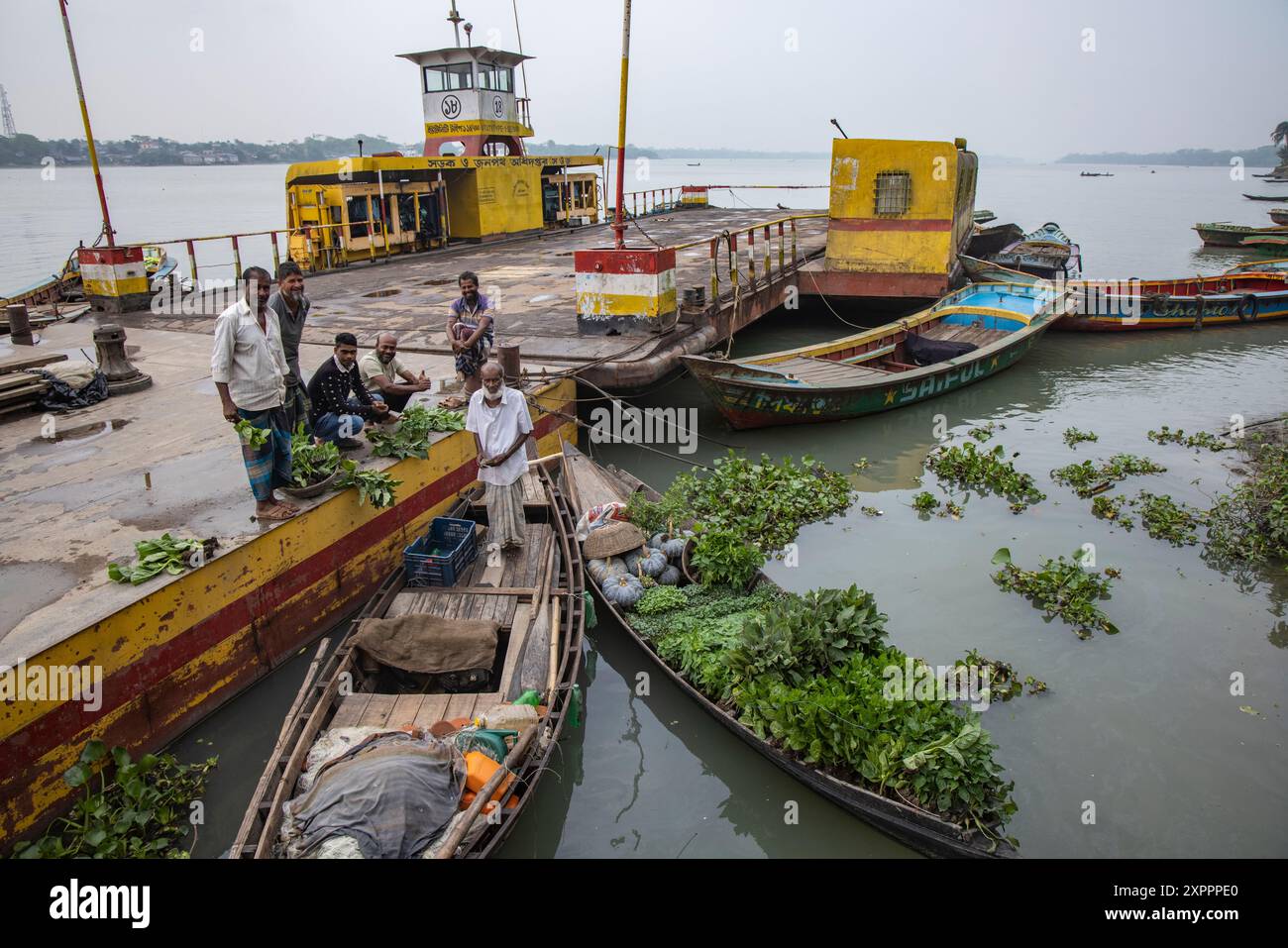 Traders selling vegetables from boats with ferry behind, Kaukhali ...