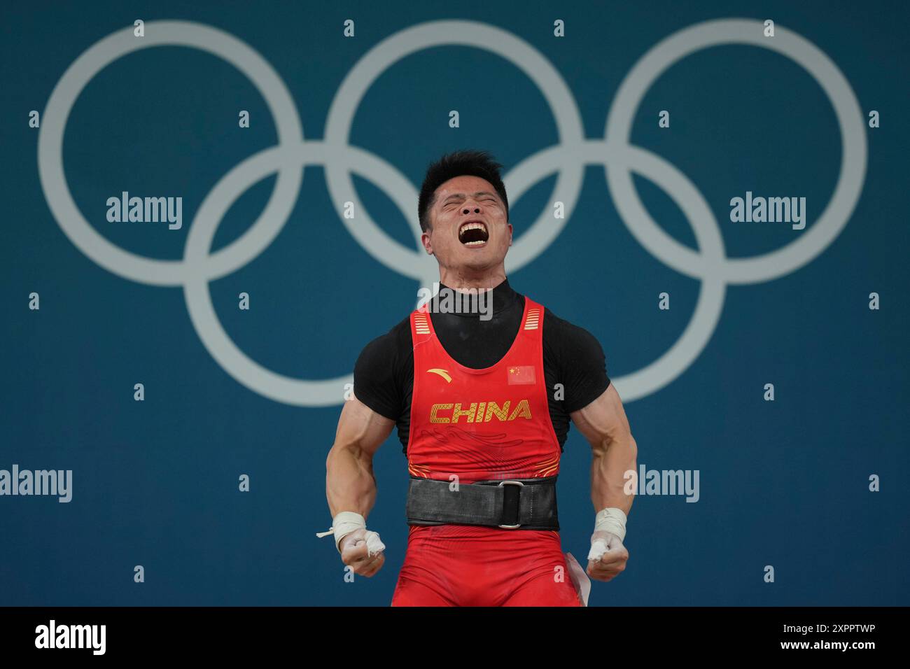 Li Fabin of China reacts as he competes during the men's 61kg ...