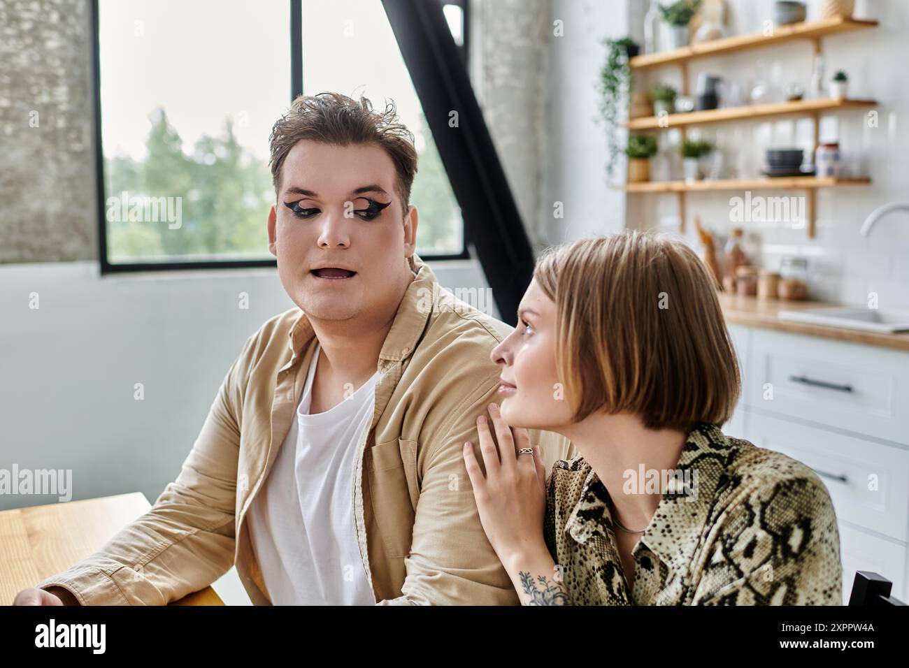 Two friends share a warm, personal moment in a stylish home setting ...